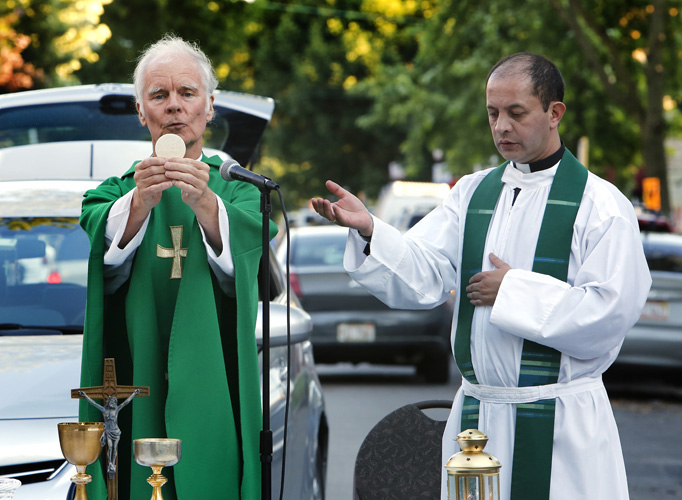 St. Agnes of Bohemia parishioners pray for peace at outdoor street ...